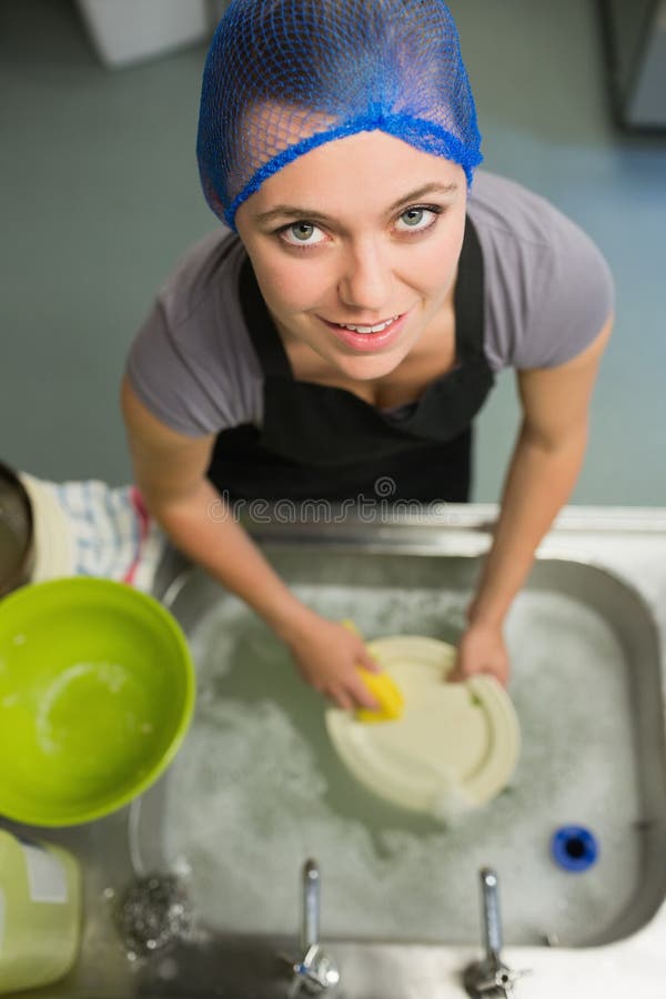 Smiling Woman Looking Up from Washing Up Stock Image - Image of washing ...