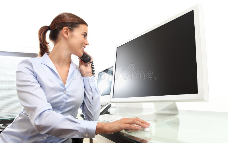 Smiling Woman in Office at Desk in Front of Computer Screen, Talking on ...