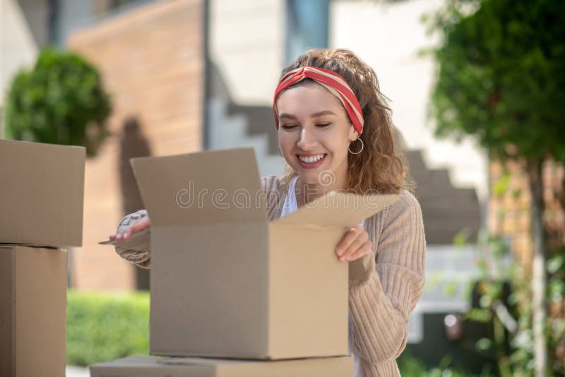 Smiling Woman Opening the Cardboard and Feeling Excited Stock Photo ...