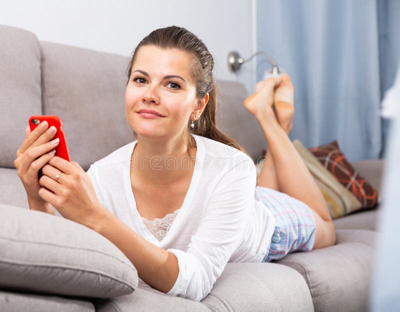 Smiling Woman with Phone Lying on Sofa Stock Image - Image of closeup ...