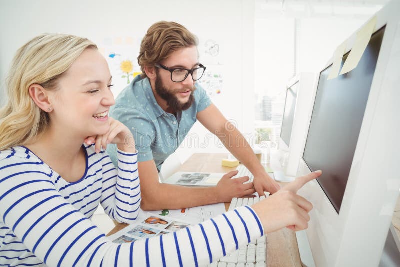 Smiling Woman Pointing at Computer Stock Image - Image of foreground ...
