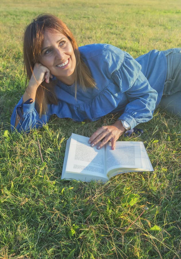 Smiling Woman Reading a Book in Nature Stock Image - Image of enjoyment ...
