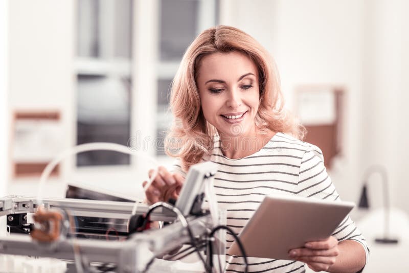 Smiling Woman Reading Instructions for the 3D Printer Stock Photo ...