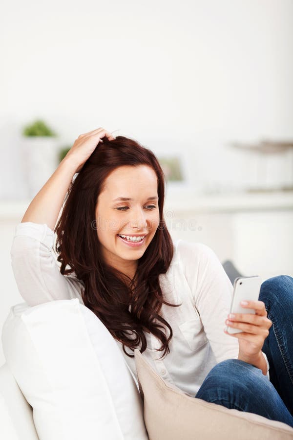 Smiling Woman Reading a Message on Her Mobile Stock Image - Image of ...