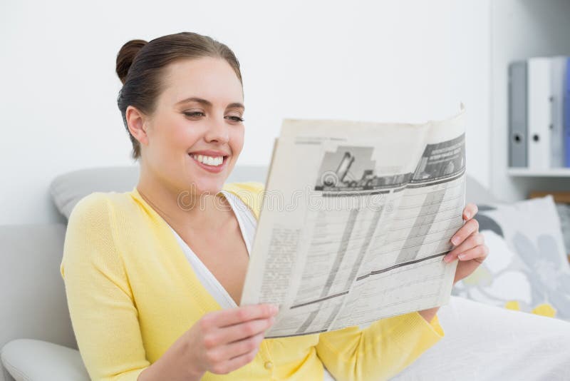 Smiling Woman Reading Newspaper on Sofa at Home Stock Image - Image of ...
