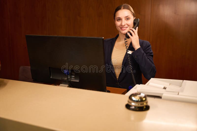 Smiling Woman Receptionist Standing and Talking on Phone Stock Photo ...