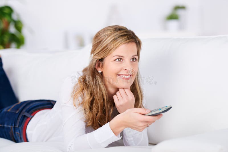 Smiling Woman with Remote Control on Sofa Stock Image - Image of ...