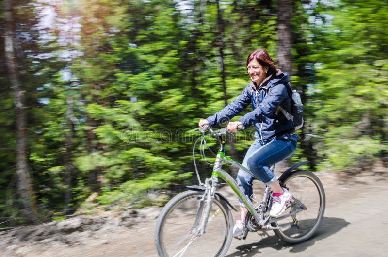 Smiling Woman Riding a Bicycle in Spring Stock Photo - Image of hill ...
