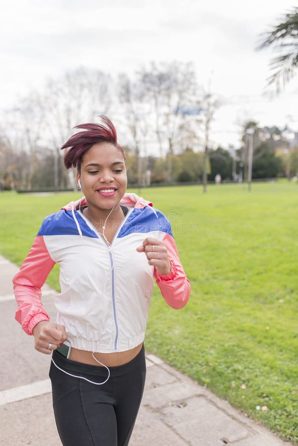Smiling woman running . stock photo. Image of jogging - 65469600