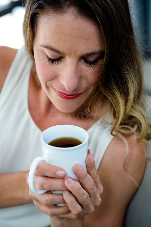 Smiling Woman Sipping a Cup of Coffee Stock Image - Image of person ...