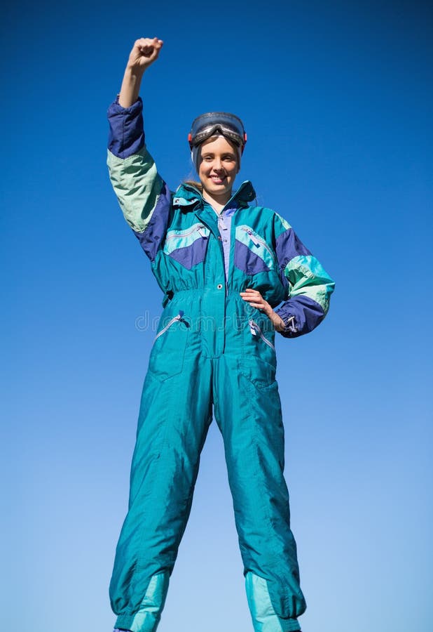 Smiling Woman in Ski Suit Putting Hand Up Stock Image - Image of long ...
