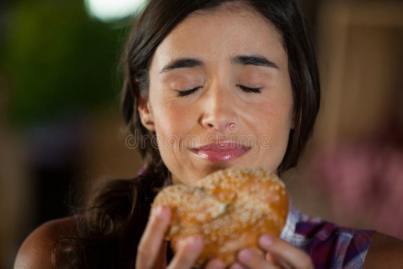 Smiling Woman Smelling a Bread at Counter Stock Photo - Image of people ...