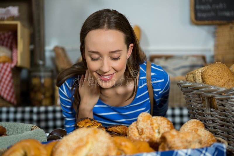 Smiling Woman Smelling a Breads at Counter Stock Image - Image of happy ...