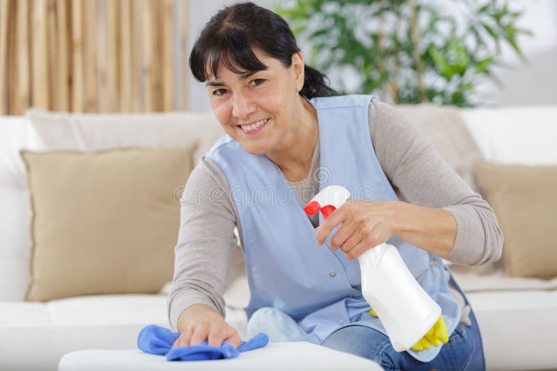 Smiling Woman Spraying Cleaning Liquid on Table Stock Photo - Image of ...