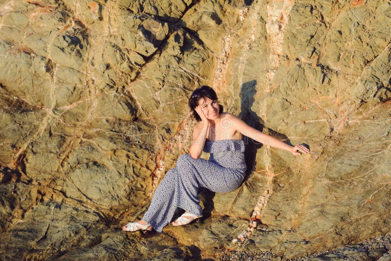 Smiling Woman on Stone stock image. Image of adult, female - 42978603