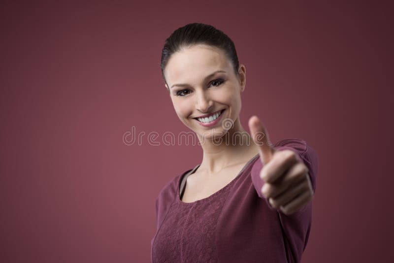 Smiling woman thumbs up stock photo. Image of determination - 68467002