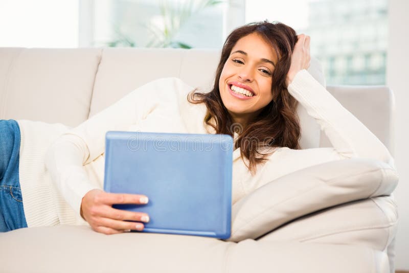 Smiling Woman Using Her Tablet on Couch Stock Photo - Image of computer ...