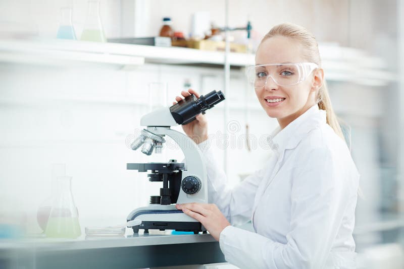 Smiling Woman Using Microscope in Laboratory Stock Photo - Image of ...