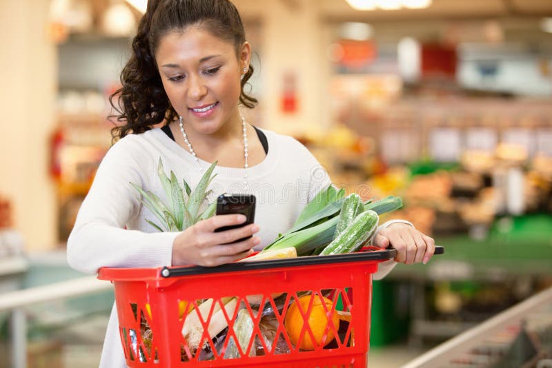 Smiling Woman Using Mobile Phone in Shopping Store Stock Photo - Image ...