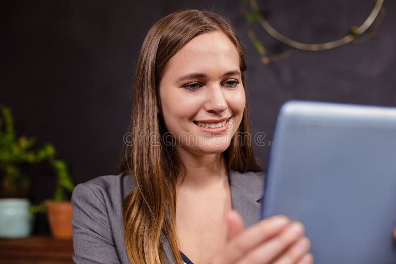 Smiling woman using tablet stock photo. Image of espresso - 66981742