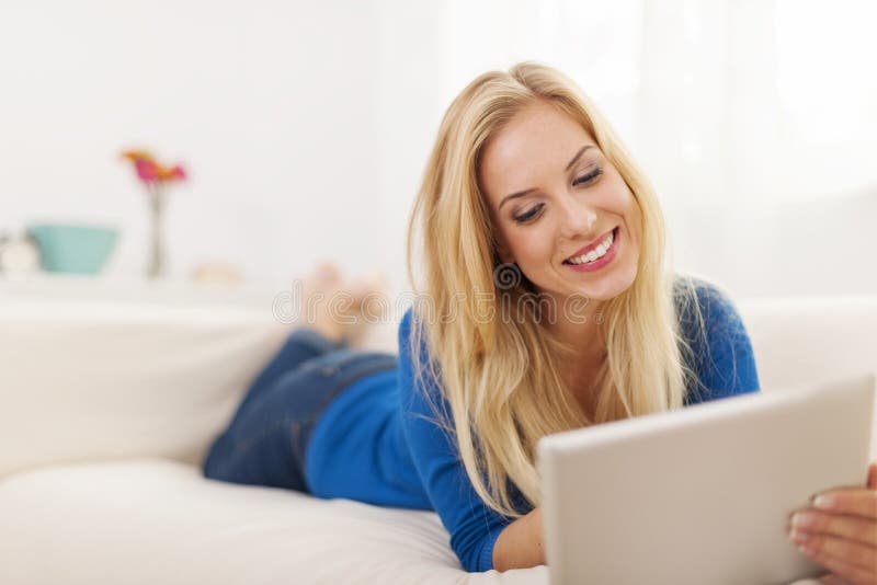 Smiling Woman Using Tablet at Home Stock Image - Image of purity, room ...