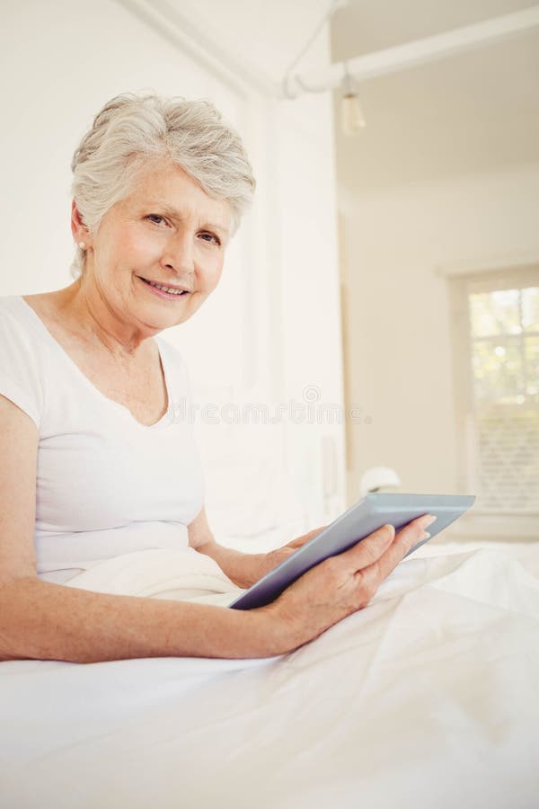 Smiling woman using tablet stock image. Image of domicile - 66434387