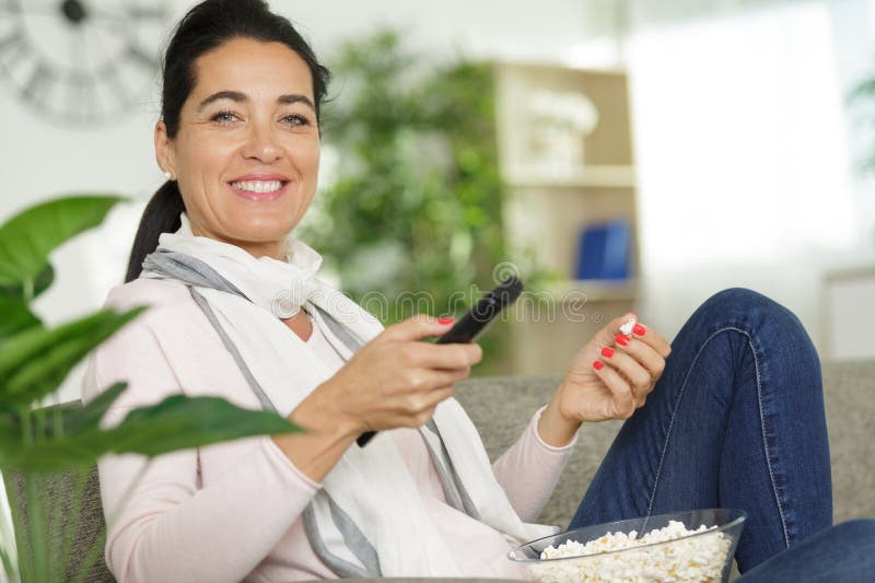 Smiling Woman Watching Tv and Eating Popcorn Stock Image - Image of ...