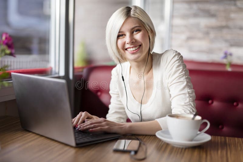 Smiling Woman Working with Laptop Computer in Cafe Stock Photo - Image ...
