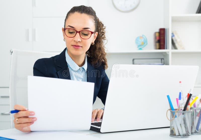 Smiling Woman Working with Paperwork and Laptop Stock Image - Image of ...