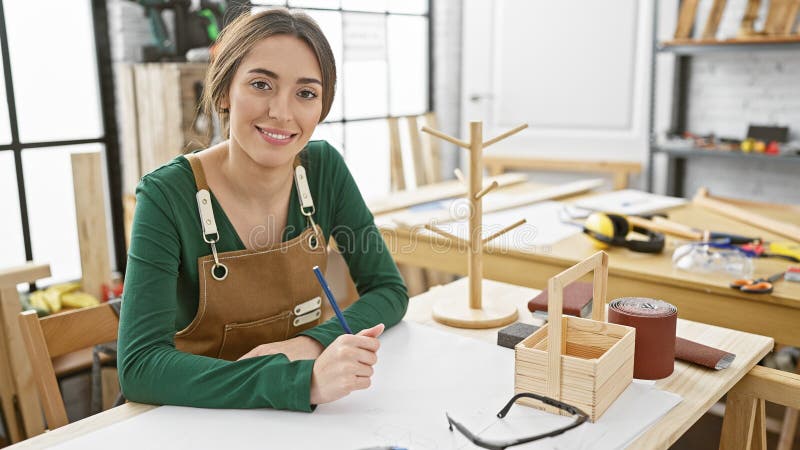 A Smiling Woman in a Workshop Sketches a Design, Surrounded by ...