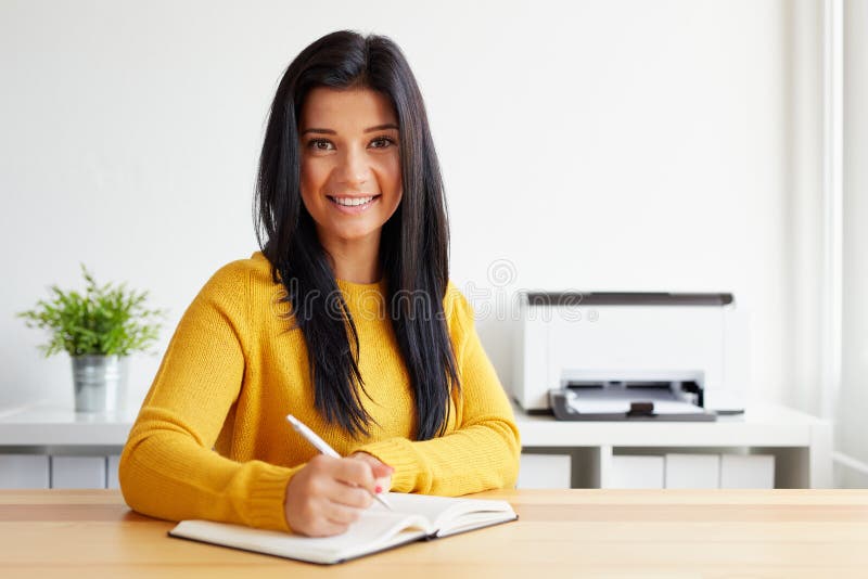 Smiling woman writes notes stock photo. Image of adult - 80628656