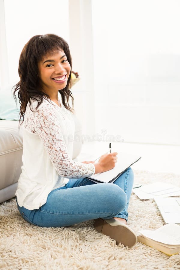 Smiling Woman Writing Notes while Looking the Camera Stock Image ...