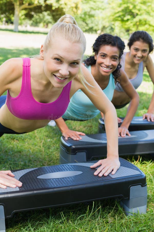 Smiling Women Doing Step Aerobics Stock Image - Image of fitness ...