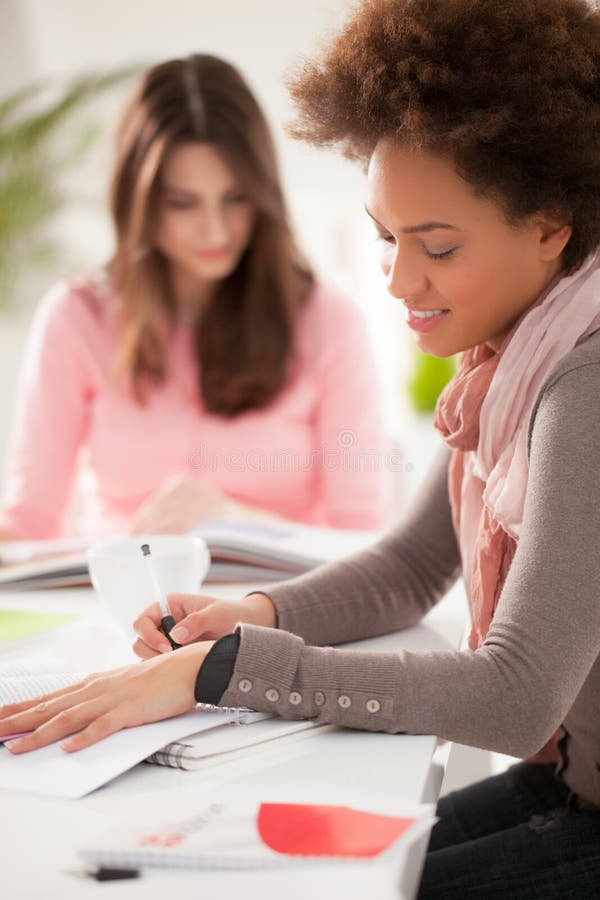 Smiling Women Studying Together Stock Image - Image of black, desk ...
