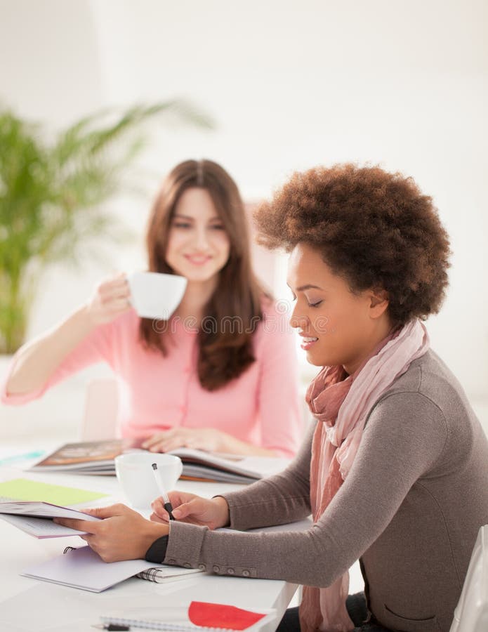 Smiling Women Studying Together Stock Image - Image of sitting, people ...