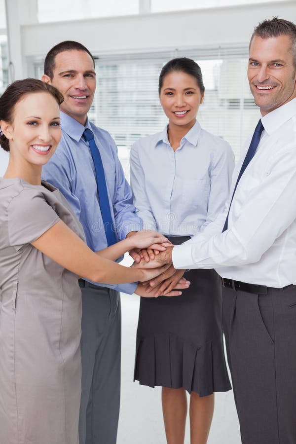 Smiling Work Team Joining Hands Together Stock Image - Image of ...