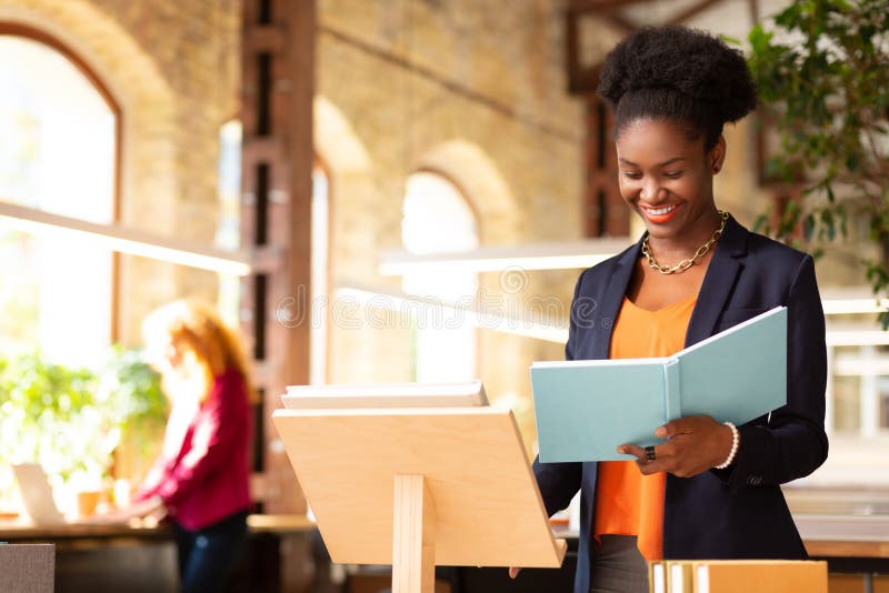 Smiling Worker of Publishing Office Looking at Book Covers Stock Photo ...