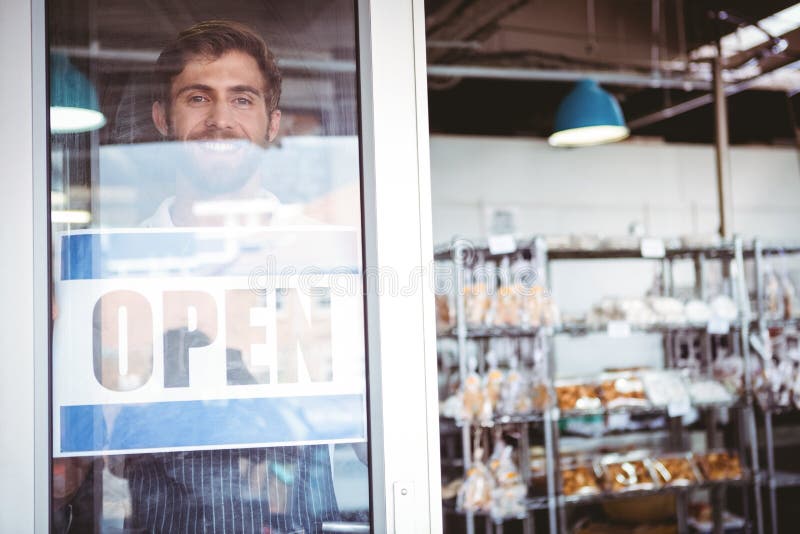 Smiling Worker Putting Up Open Sign Stock Photo - Image of house ...