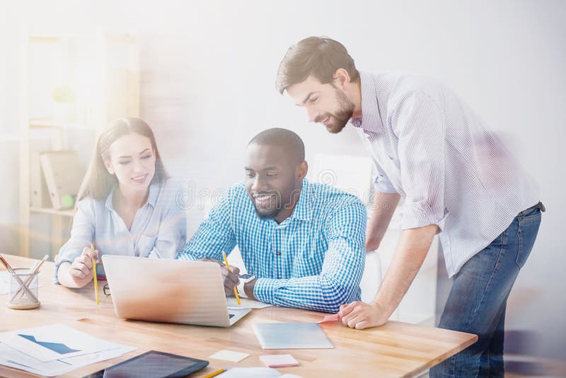 Smiling Workers Using Laptop in Office Stock Image - Image of interface ...