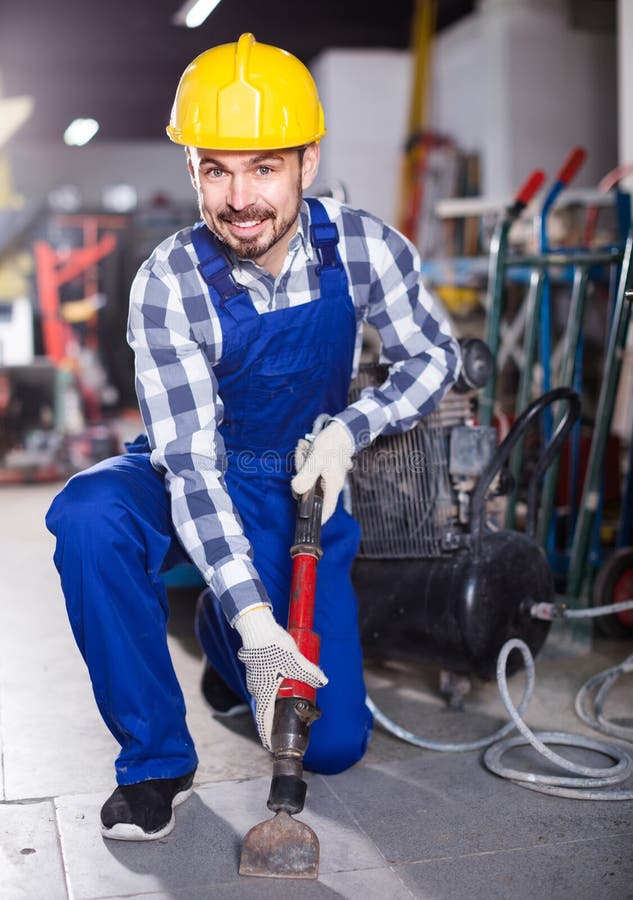 Working Man Practicing His Skills with Pneumatic Drill at Workshop ...