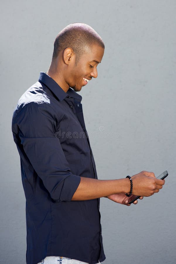 Smiling Young African Man Using Mobile Phone Stock Image - Image of ...