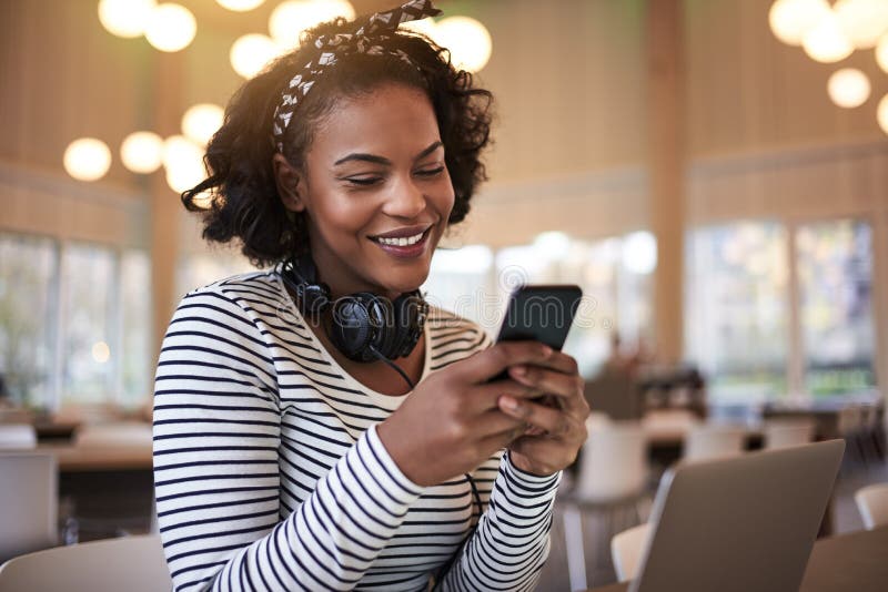 Smiling Young African Student Reading Texts while Studying at Sc Stock ...