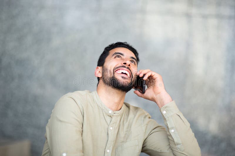 Smiling Young Arabic Guy Talking on Cell Phone Stock Photo - Image of ...