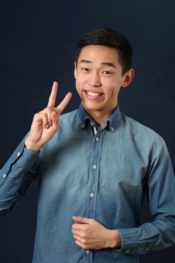 Smiling Young Asian Man Giving the Victory Sign Stock Image - Image of ...