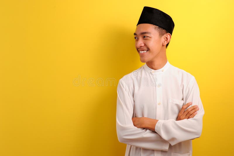 Smiling Young Asian Muslim Man with Welcome Gesture during Ramadan ... Smiling Young Asian Muslim Man with Welcome Gesture during Ramadan ...
