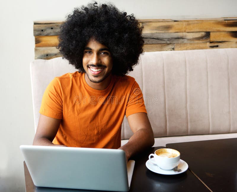 Smiling Young Black Man with Laptop on Cafe Table Stock Image - Image ...