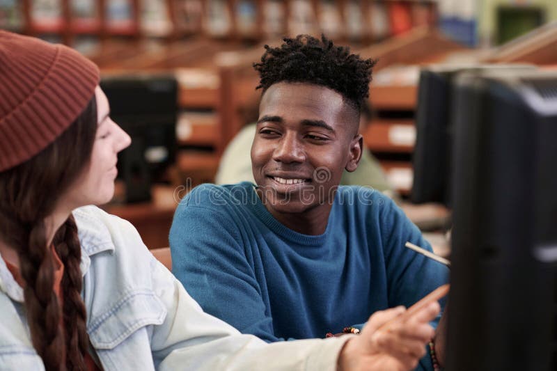 Smiling Young Black Man Talking To Friend in Library Stock Image ...