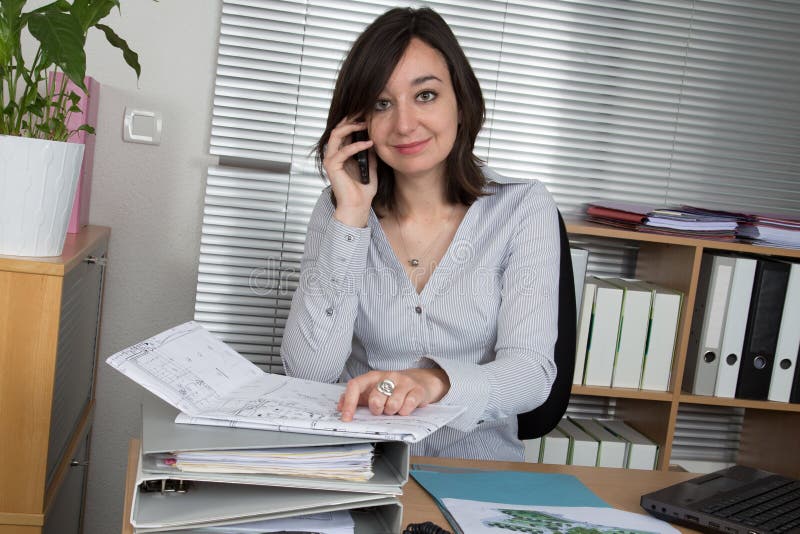 Smiling Young Business Woman on Phone Taking Notes in Office Stock ...