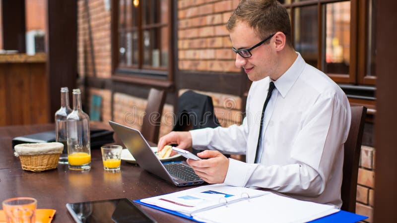 Smiling Young Businessman Making a Call with His Smartphone in a ...