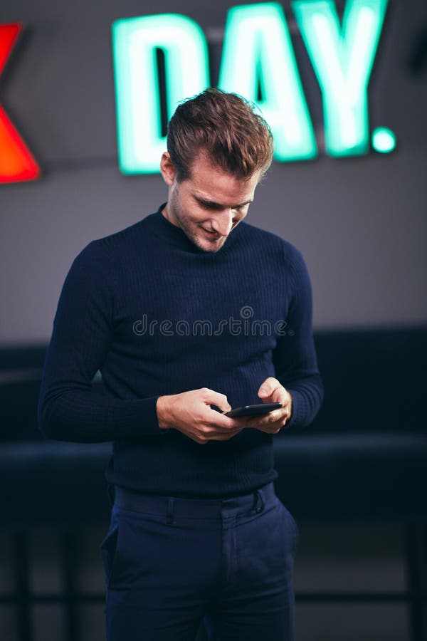 Smiling Young Businessman Sending a Text Message at Work Stock Photo ...